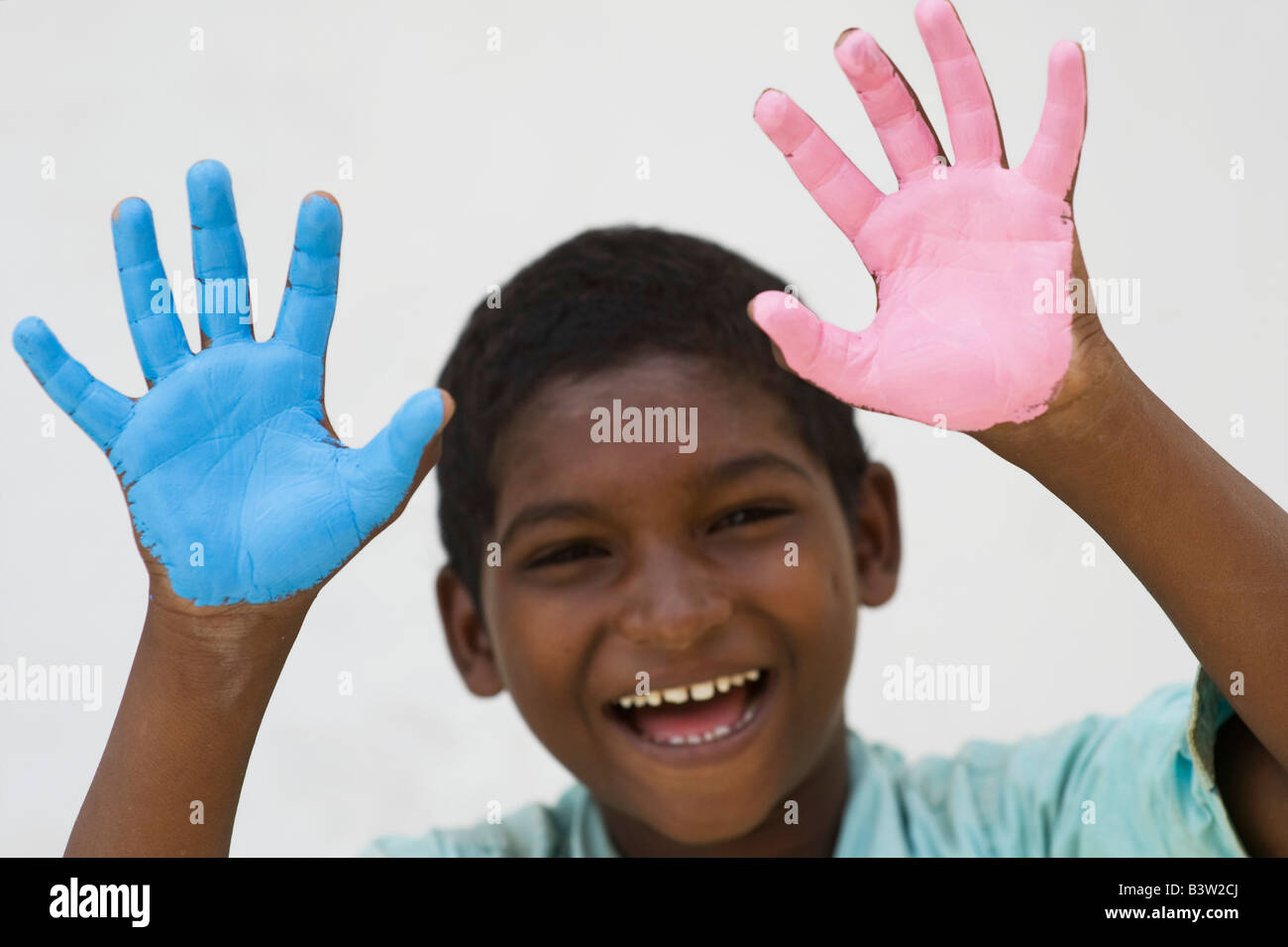 Indian boy with blue and pink painted hands. India Stock Photo - Alamy