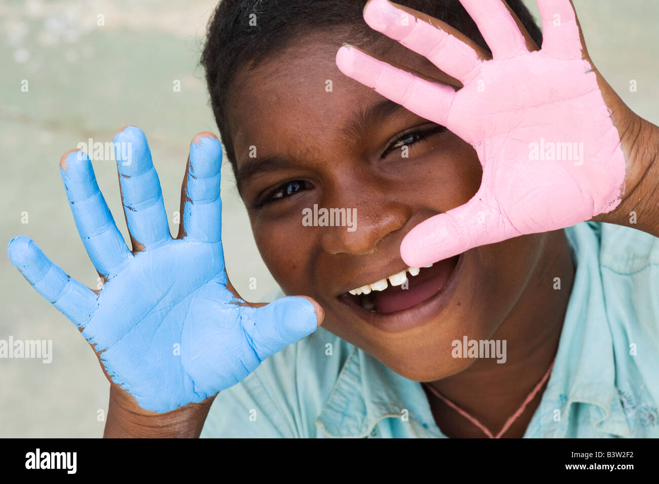 Indian boy with blue pink painted hands. India Stock Photo - Alamy