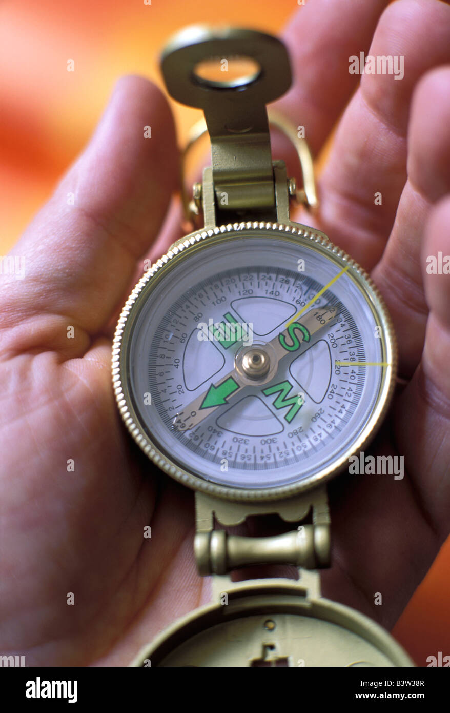Man holding compass in hand, close-up Stock Photo - Alamy