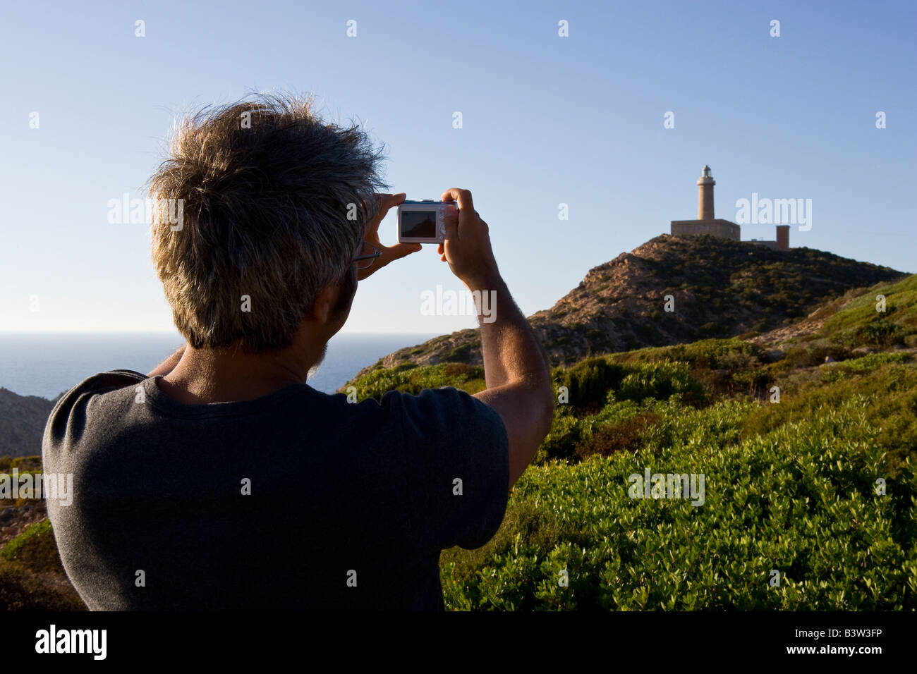 Man takes a picture of a lighthouse with a digital camera Stock Photo ...