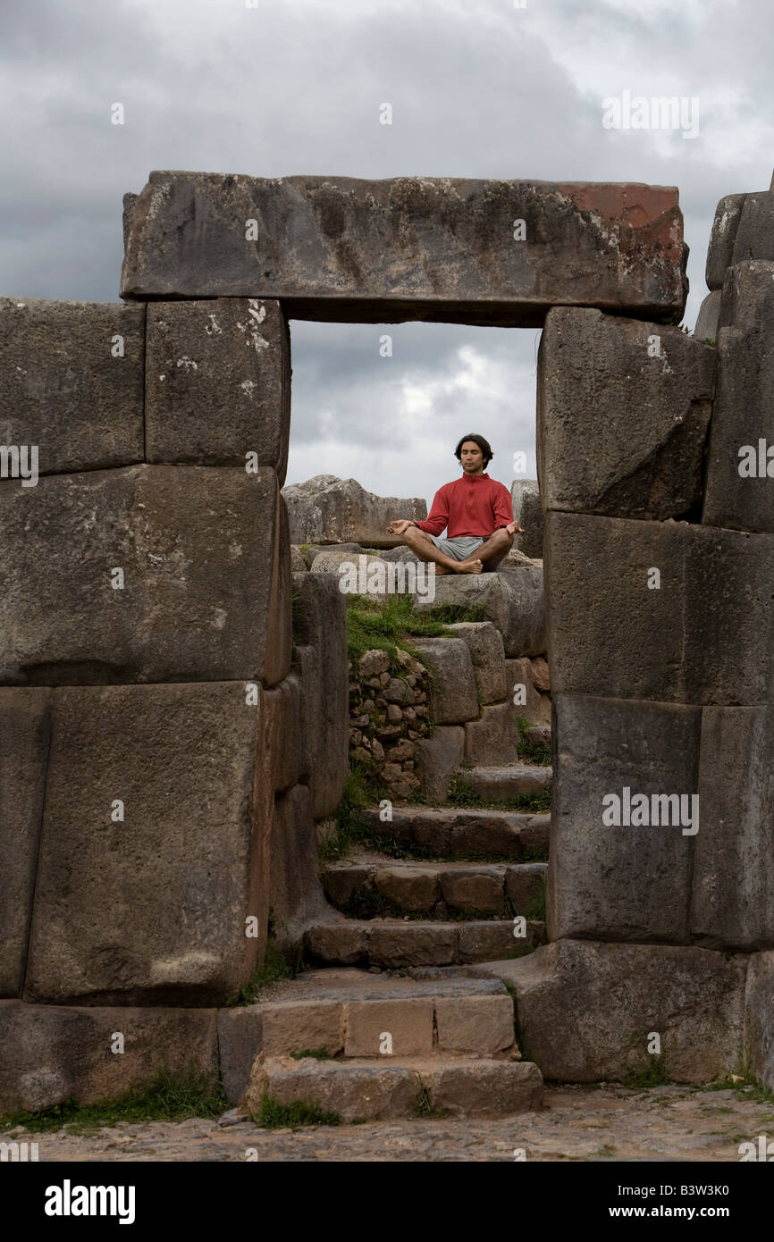 A young man meditates in ancient Incan ruins outside Cuzco, Peru Stock ...