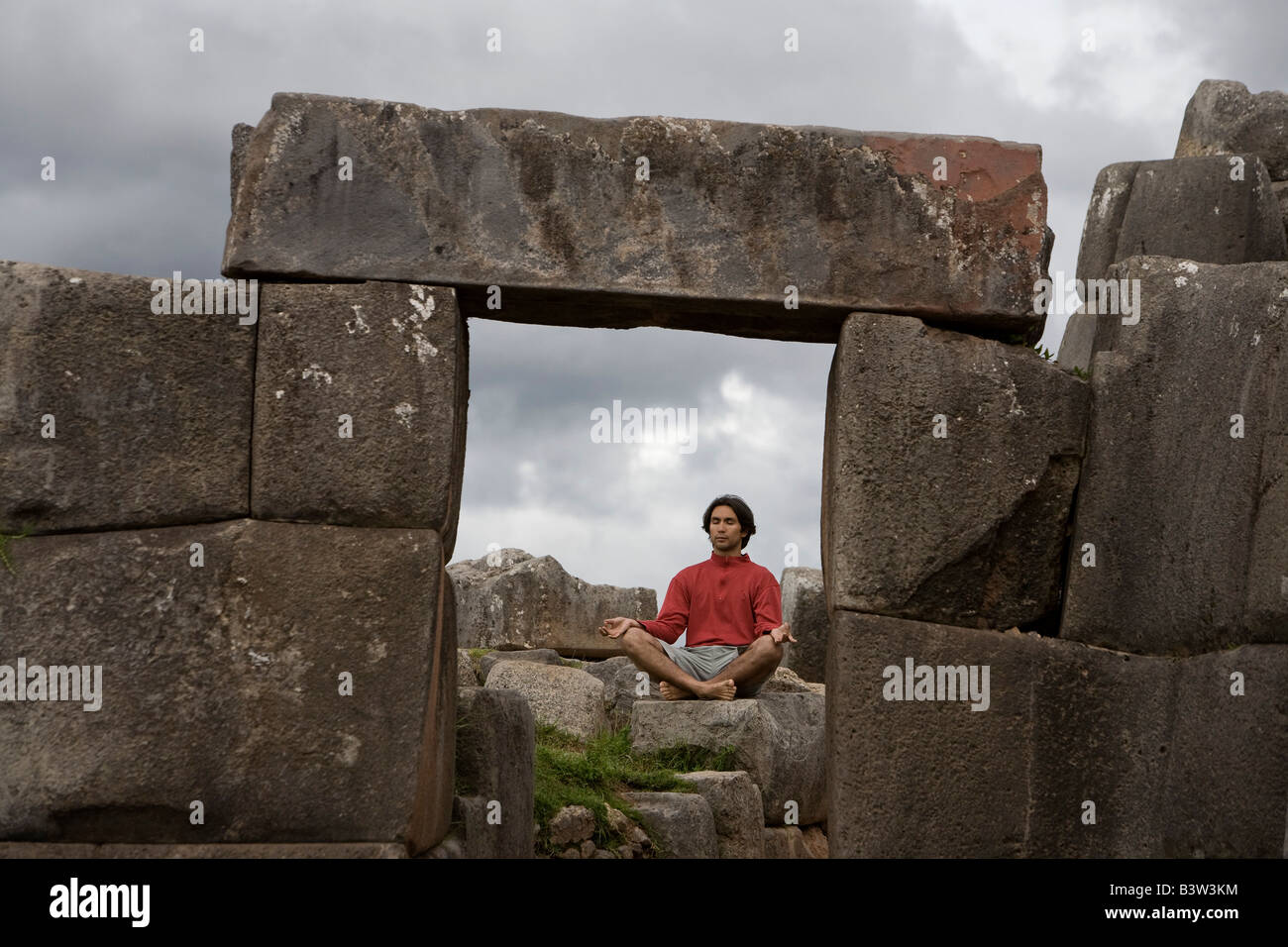 A young man meditates in ancient Incan ruins outside Cuzco, Peru Stock ...