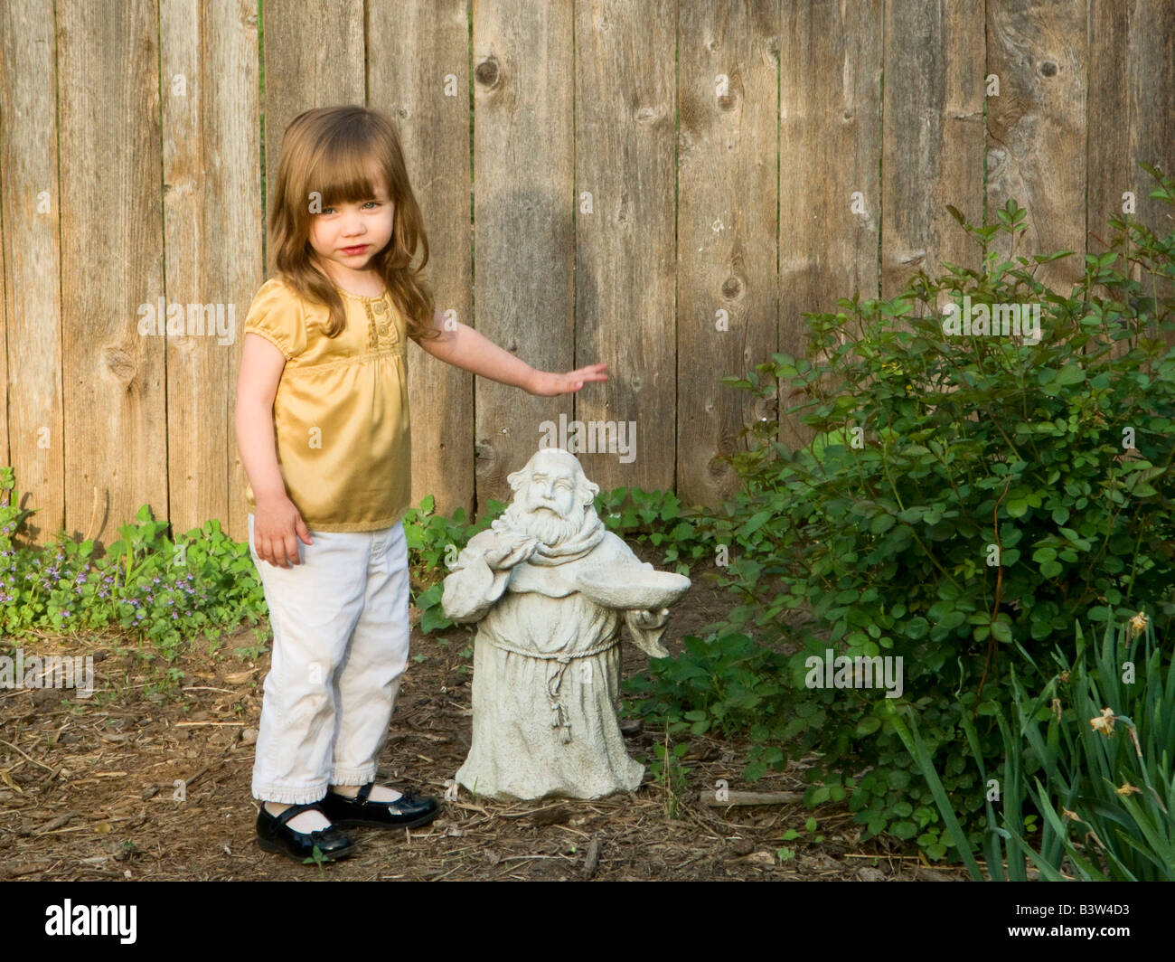 Little Girl with Statue Stock Photo - Alamy