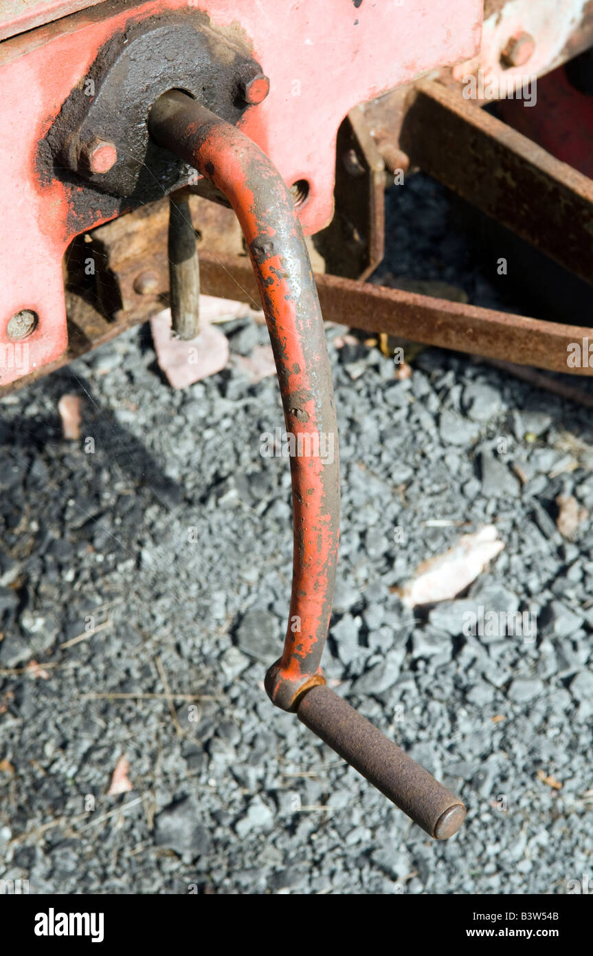 Old starting handle on a red tractor Stock Photo - Alamy