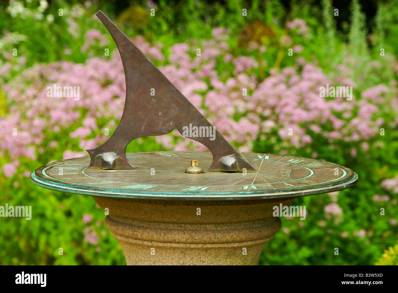 An antique sun dial in a garden Stock Photo - Alamy