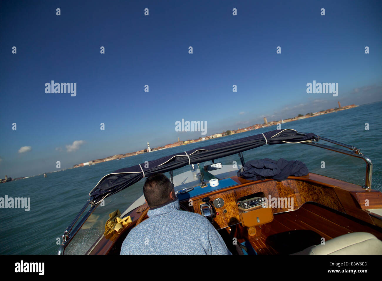 Man in taxi boat in Venice Stock Photo - Alamy
