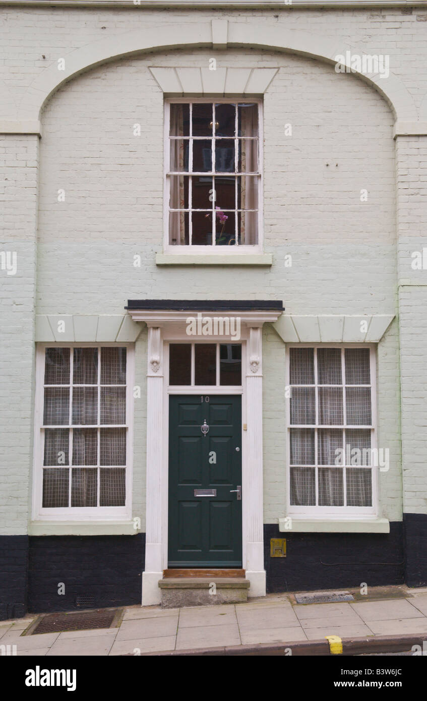Green front door with white frame and glazed fanlight on townhouse in ...