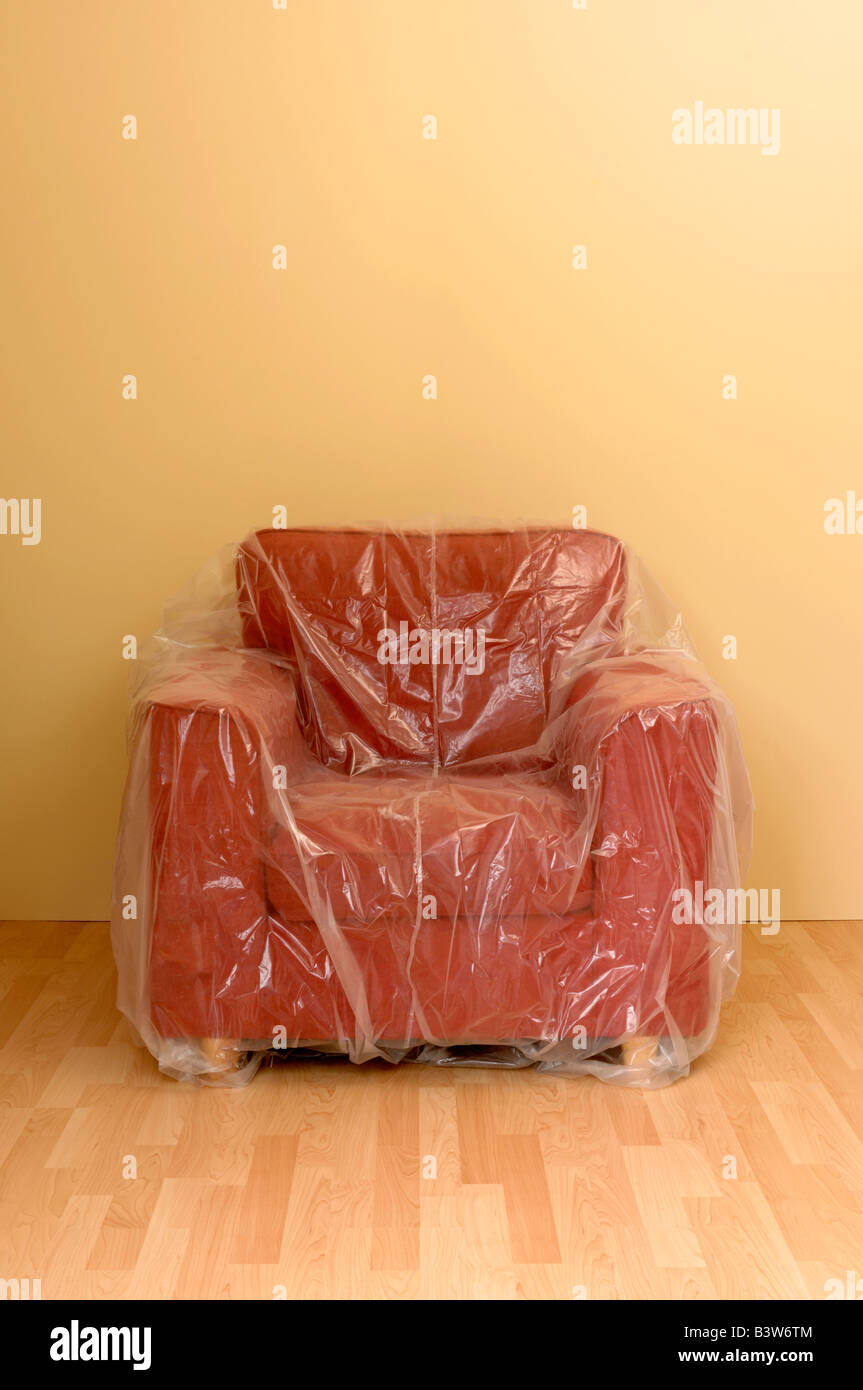 Armchair wrapped in polythene Stock Photo - Alamy