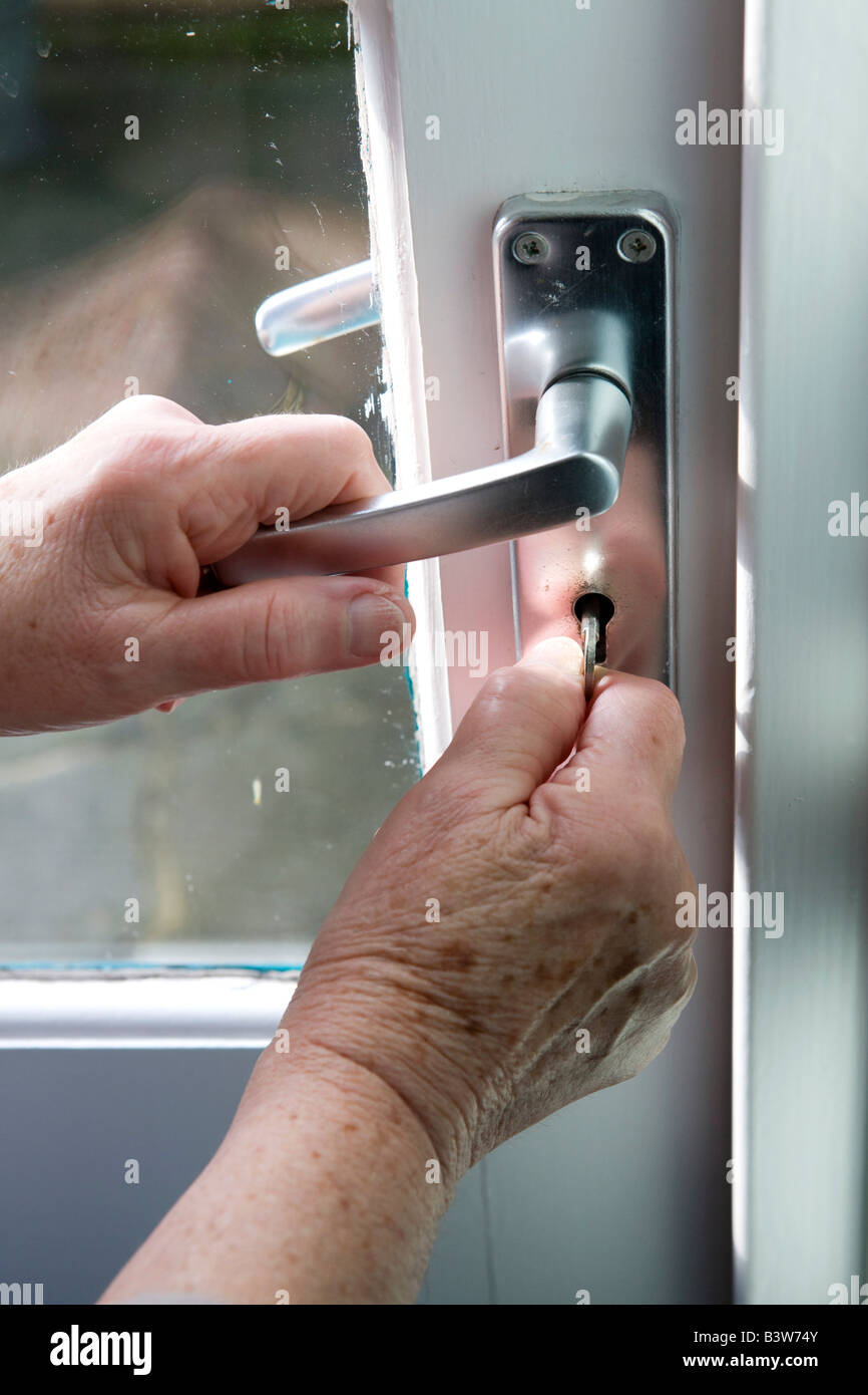 hands of elderly woman locking door Stock Photo - Alamy