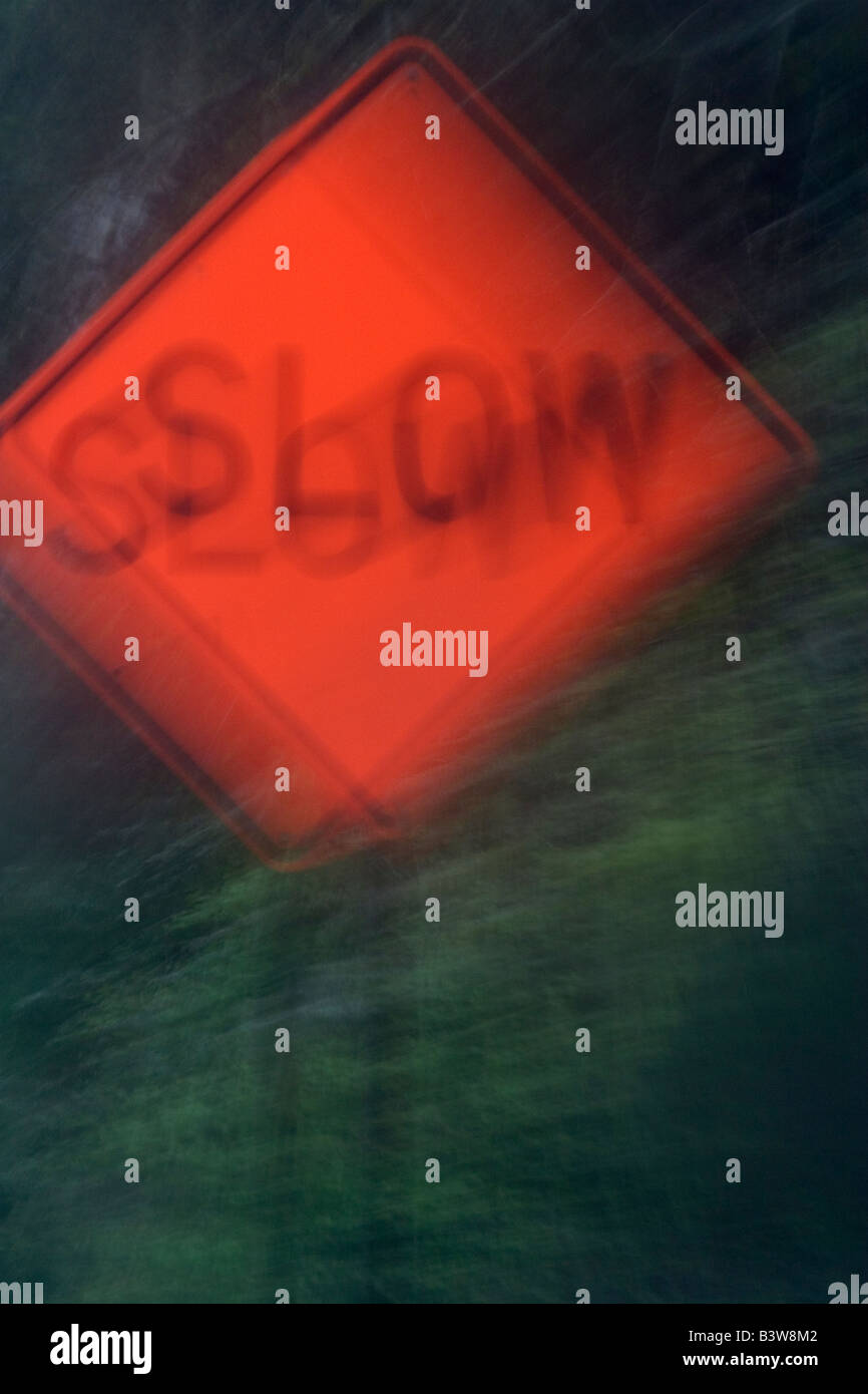 Traffic sign warning to slow down Stock Photo - Alamy