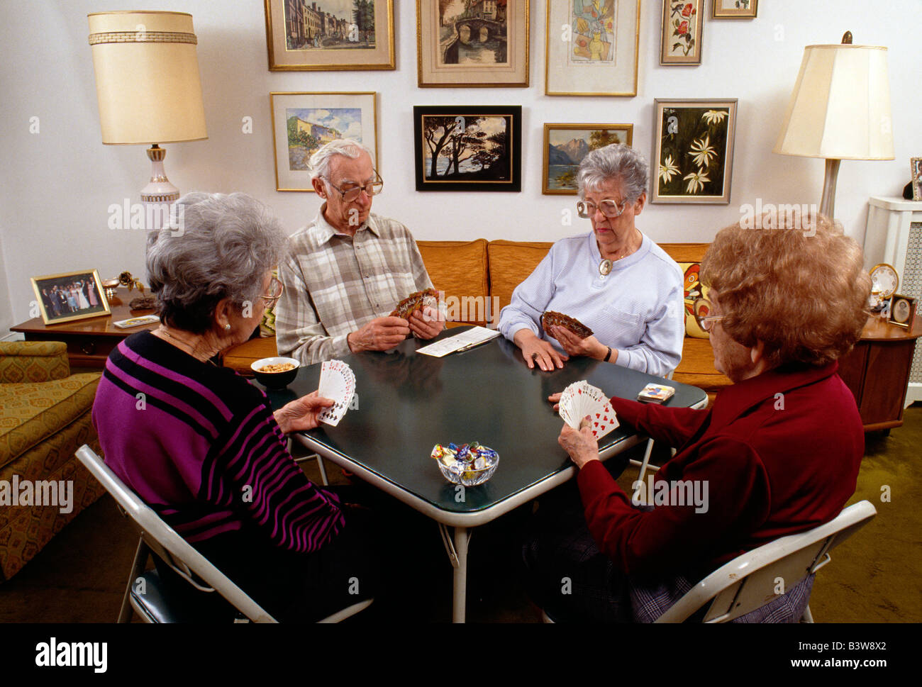 Four friends playing game cards hi-res stock photography and images - Alamy