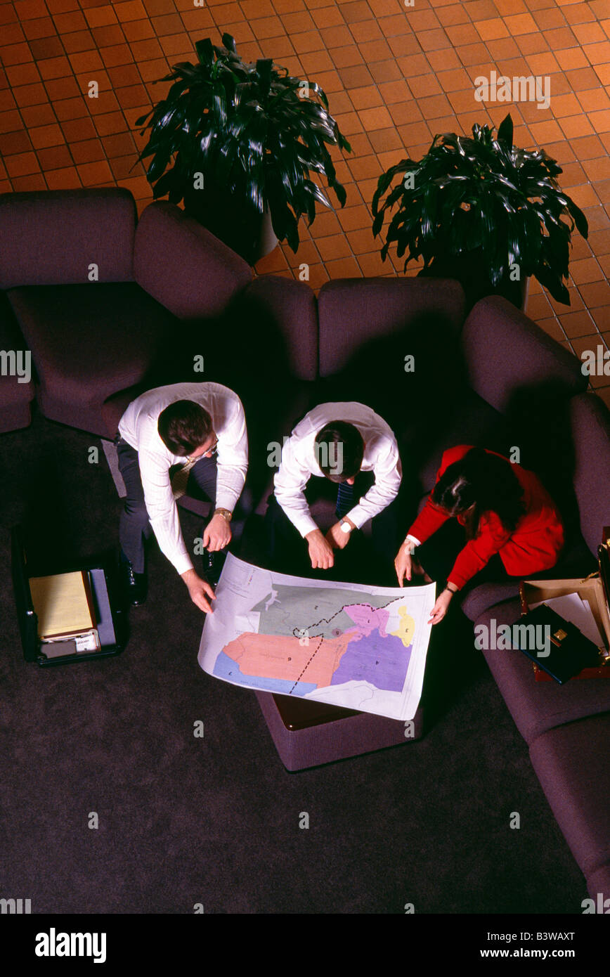 Overhead view of business people meeting in the lobby of a corporate ...