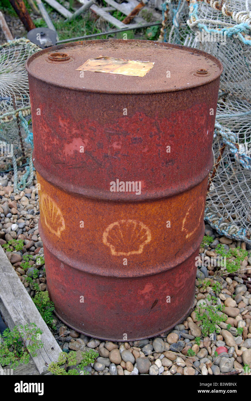 A rusty Shell oil barrel on the beach. Signifies pollution Stock Photo ...