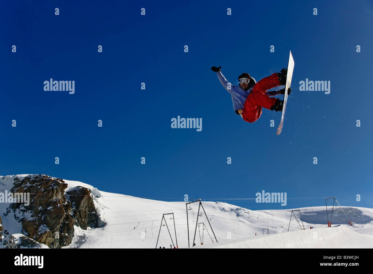 Snowboarder jumping in halfpipe, Klein Matterhorn, Zermatt, Switzerland ...