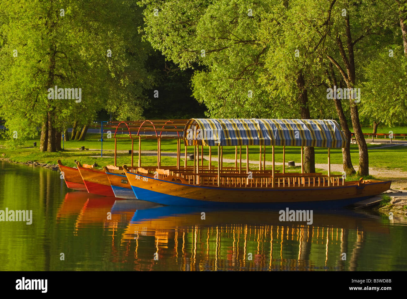Colorful boats along shoreline of Lake Bled at sunrise, Bled, Slovenia ...