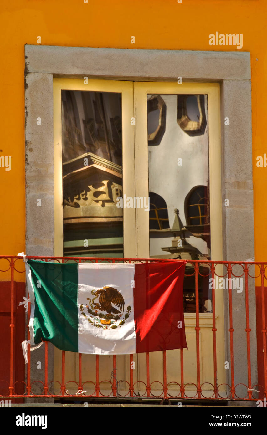 Mexico, Guanajuato. Mexican flag on rail with reflection in window ...