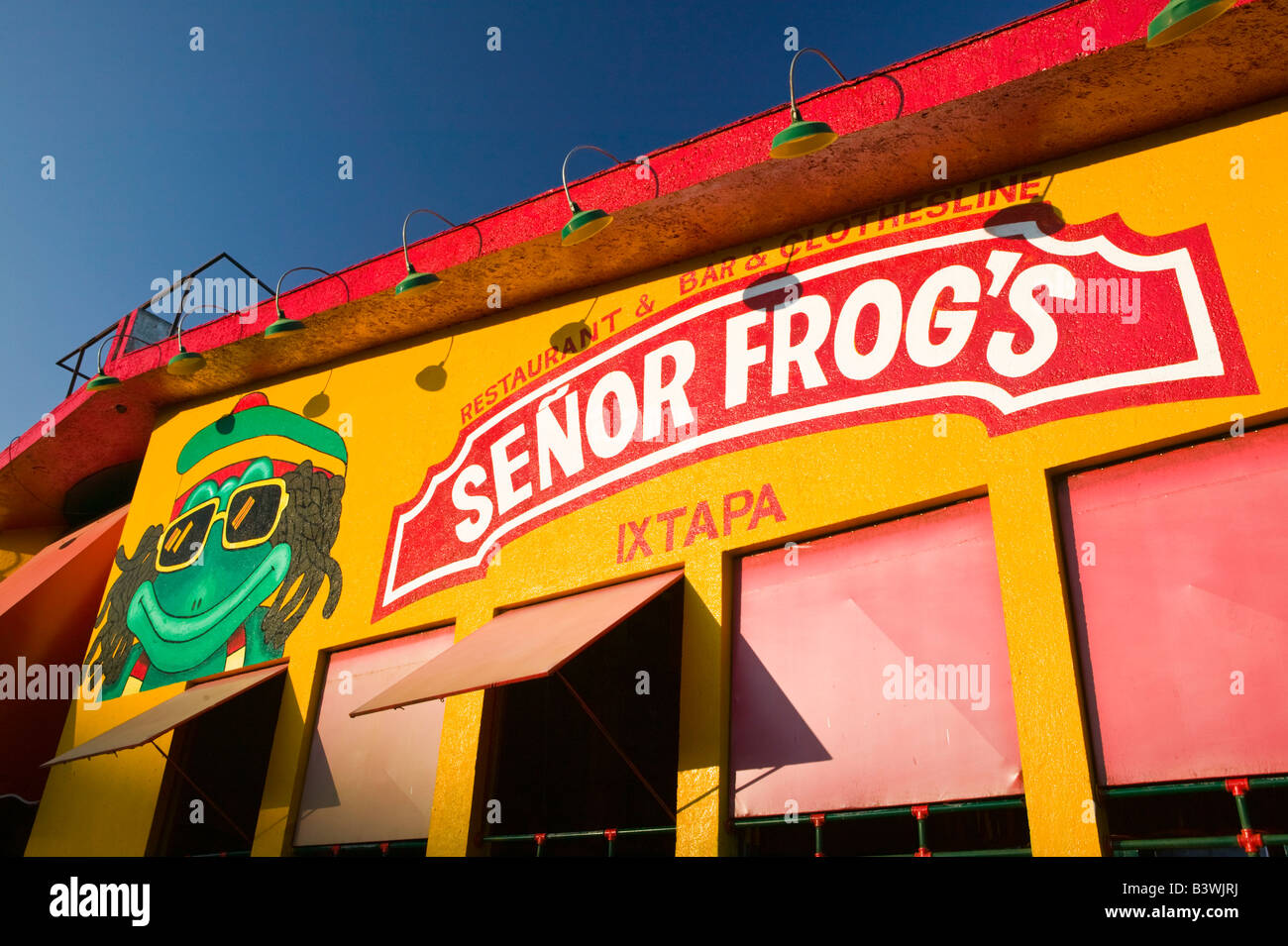 Mexico, Guerrero, Ixtapa. Sign for Senor Frog's Bar / Sunset Stock ...