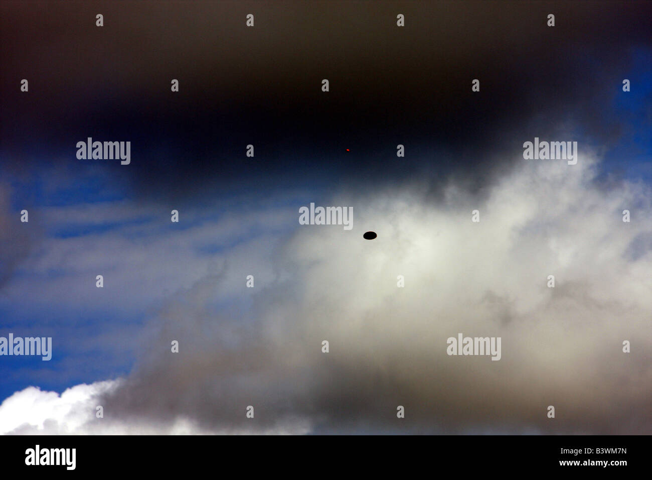 Two clay targets flying through the sky at a skeet shooting range in ...
