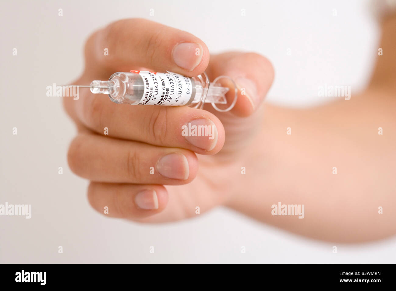 Close up hand holding syringe hi-res stock photography and images - Alamy