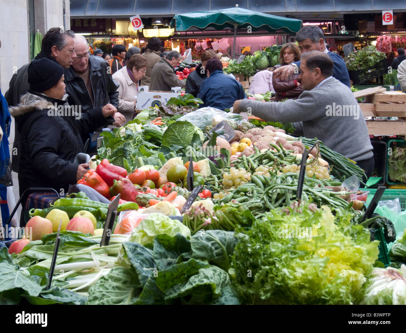 People buying fruits and vegetables in a market, Barcelona, Catalonia ...