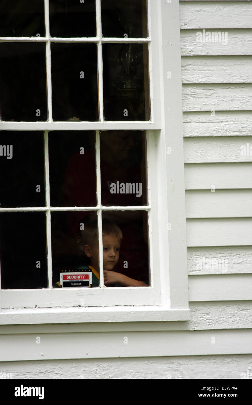 Boy standing in the window of a historical building Stock Photo - Alamy