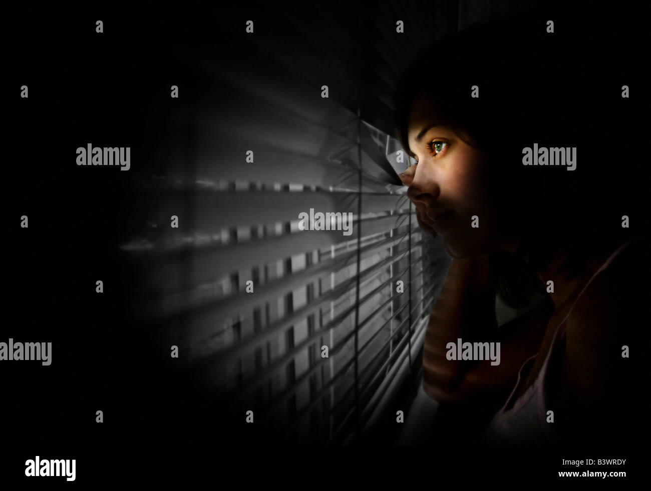 Girl peeking out of window Stock Photo - Alamy