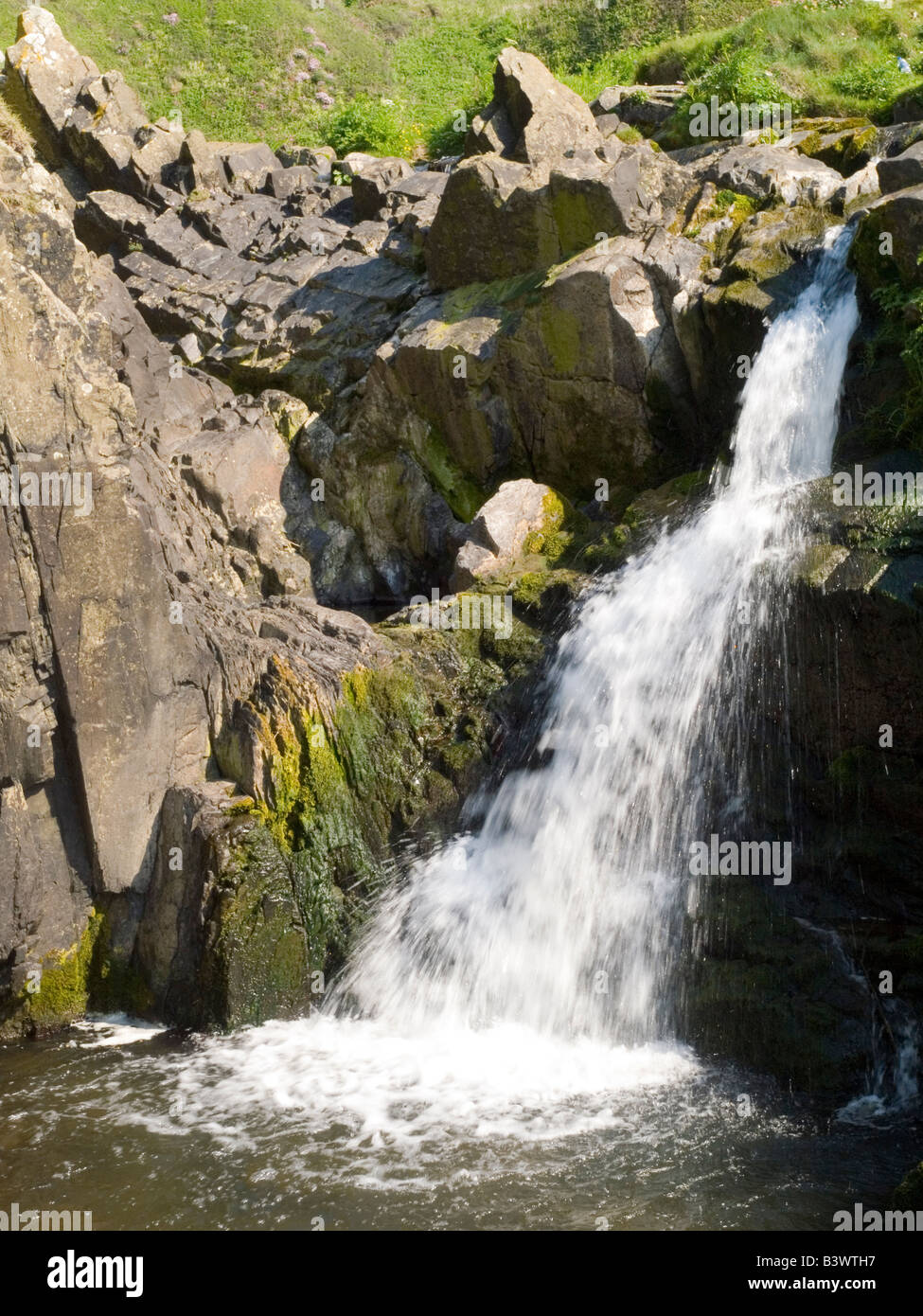 A pretty waterfall amongst the rocks at the secluded Welcombe Mouth Bay ...