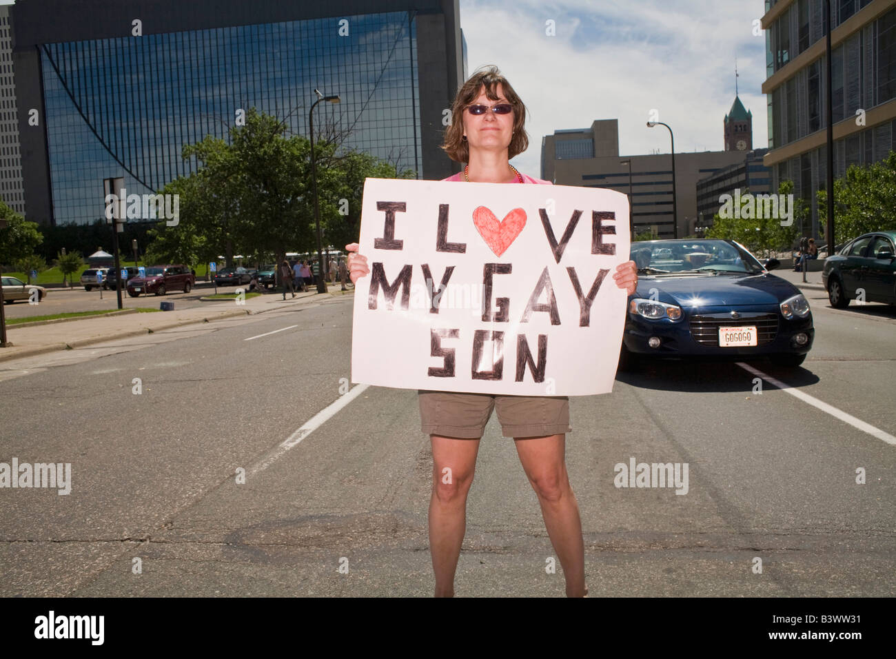 Woman holding a placard in a gay pride parade, Minneapolis, Minnesota ...
