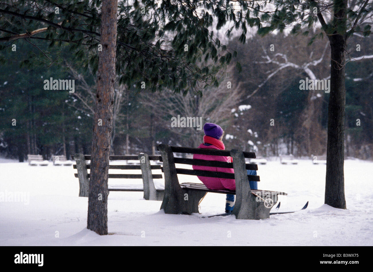 Cross country skiier resting on park bench Stock Photo - Alamy