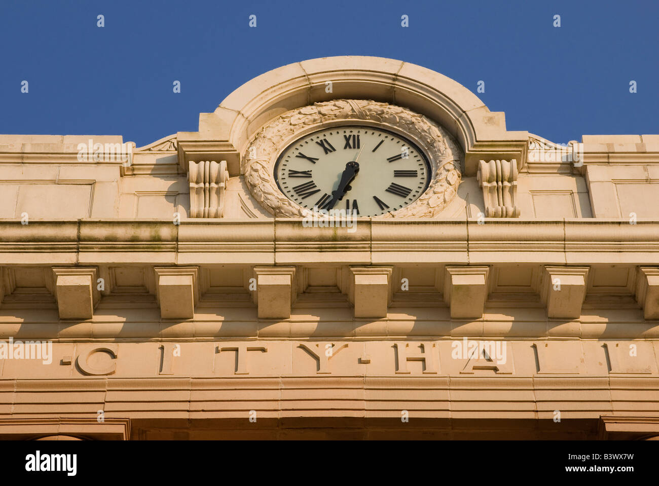 Clock above city hall Stock Photo - Alamy