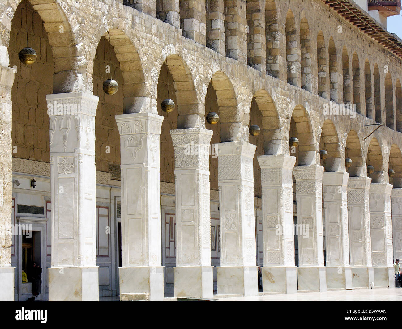 An arched arcade surrounds the court of the Umayyad Mosque in Damascus ...