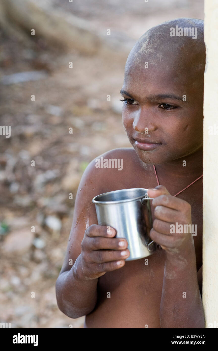 Indian boy with metal mug, drinking water Stock Photo - Alamy