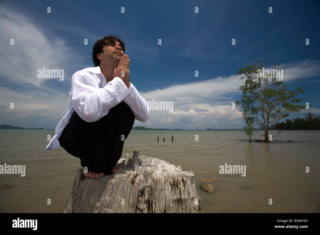 Man praying by the beach, Koh Lanta, Thailand Stock Photo - Alamy