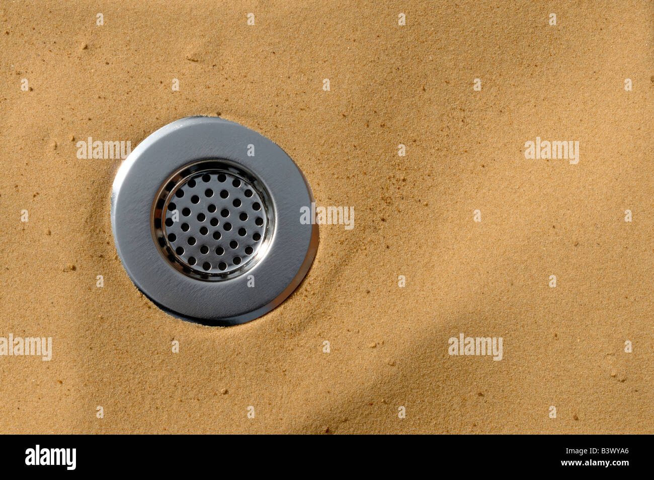 Plug hole in sand Stock Photo - Alamy
