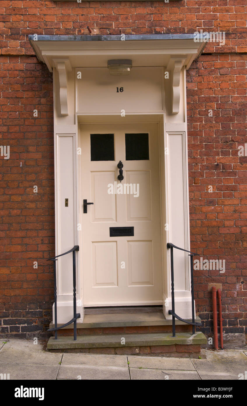 Cream coloured part glazed front door with canopy of townhouse in ...