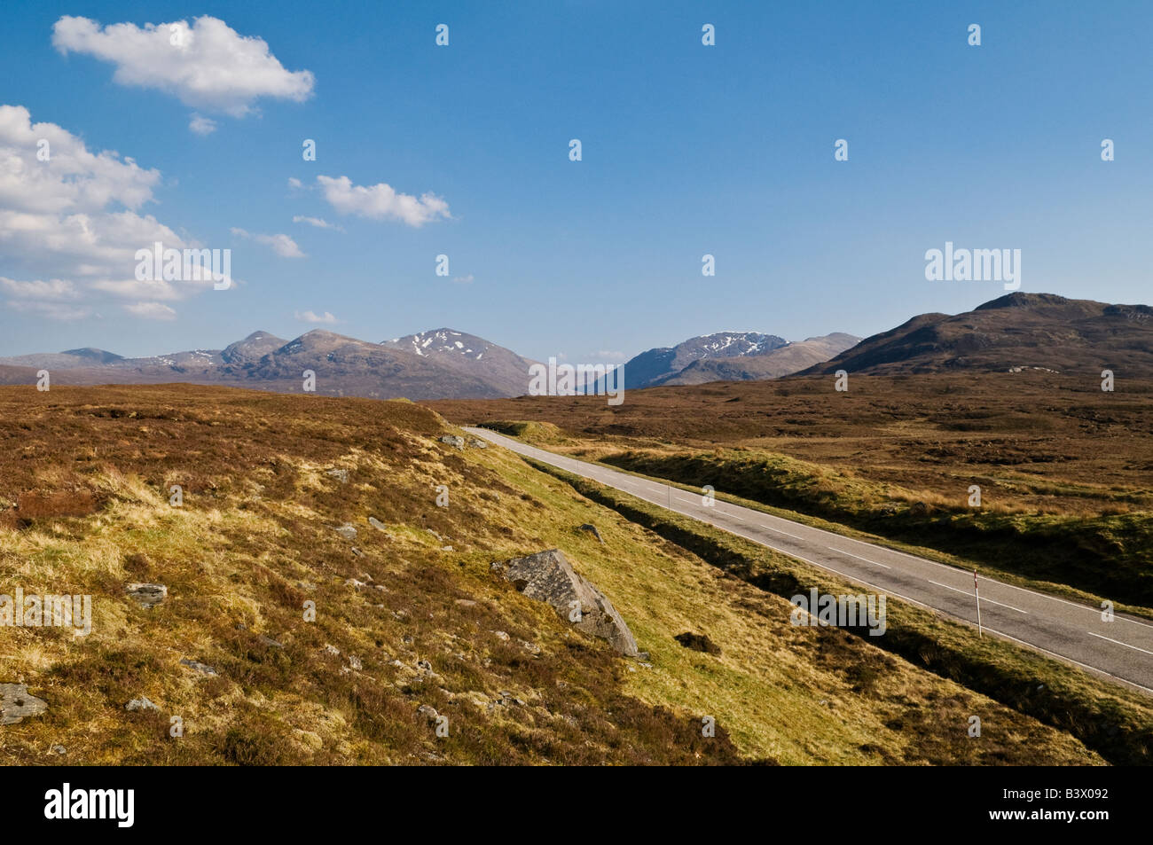 Empty highway A832 runs through rugged mountain terrain of Wester Ross ...