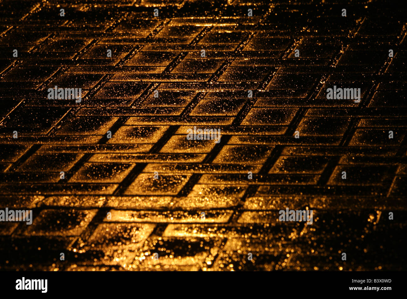 Street lights reflecting on block paving Stock Photo - Alamy