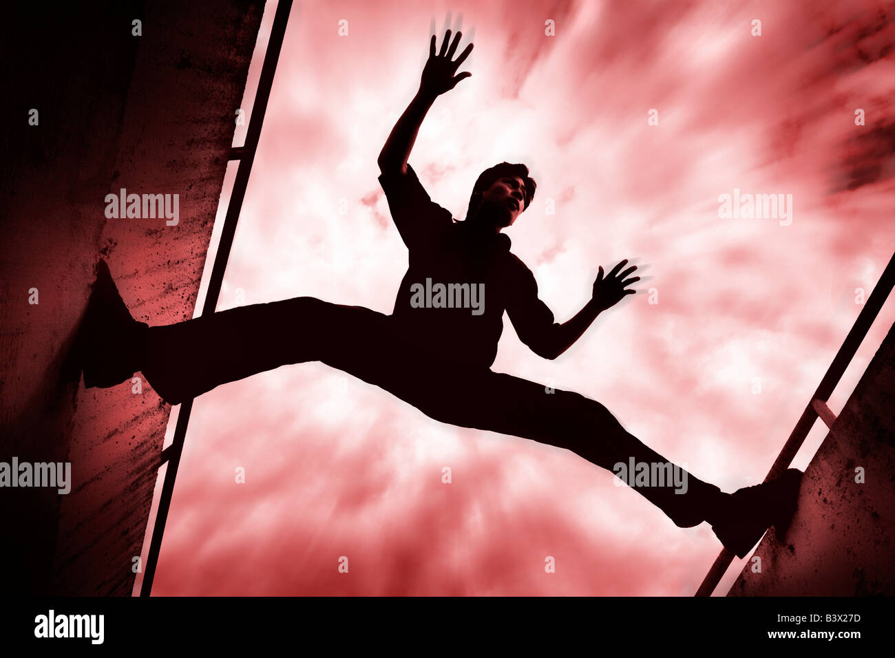 Man stretching between two walls Stock Photo - Alamy