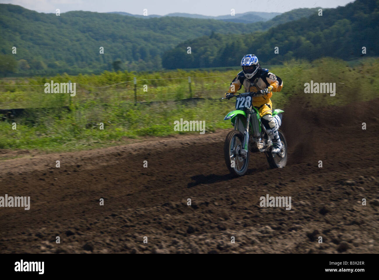 Man jumping on a motocross track with sky in the background Stock Photo ...