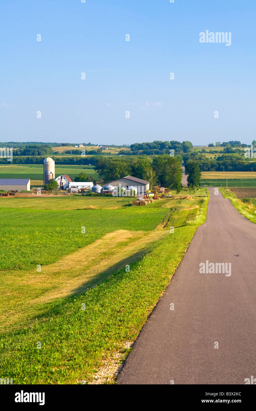 Farm set next to a long road Stock Photo - Alamy