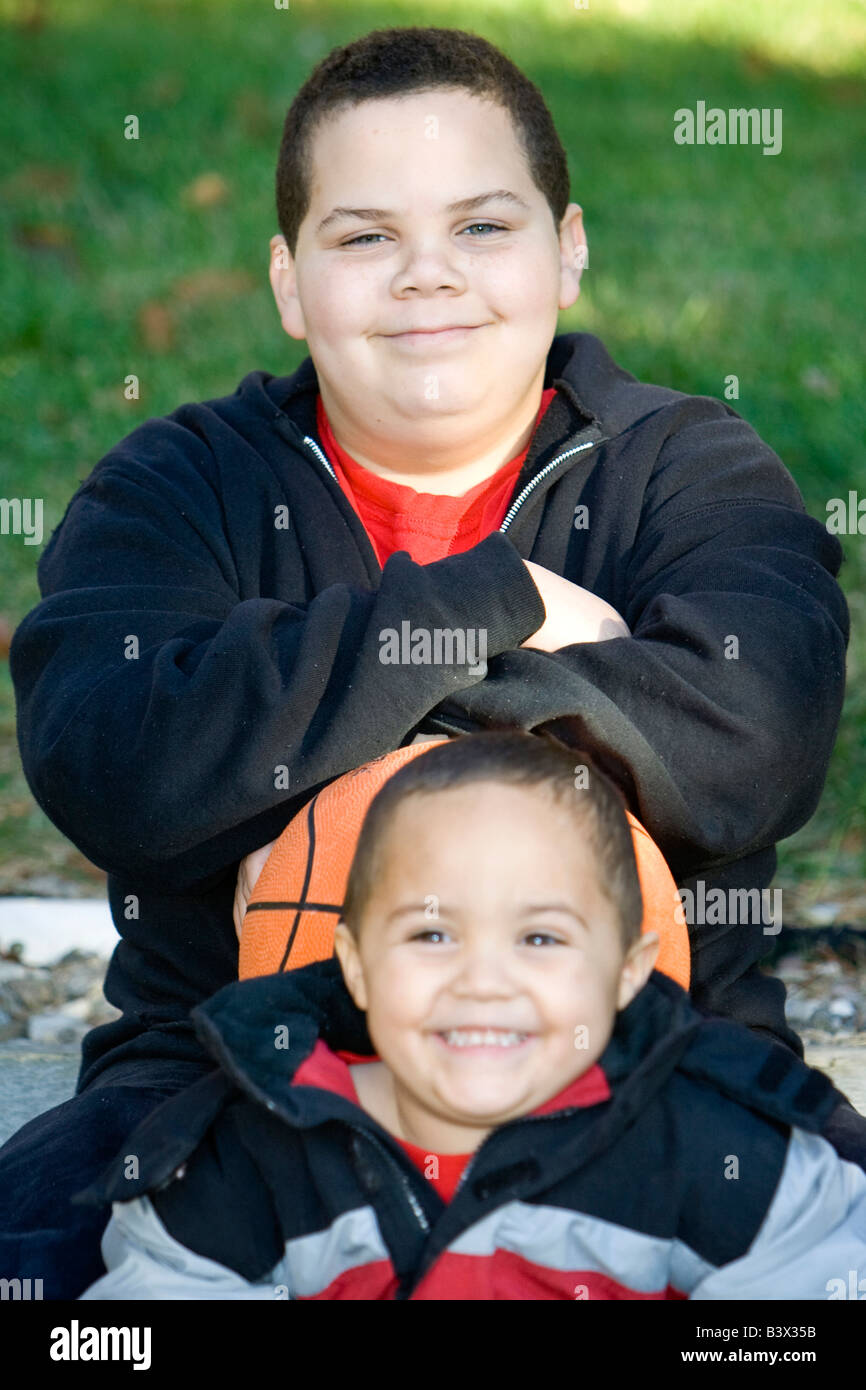 Two brothers outdoor smiling portrait with focus on older brother Stock ...
