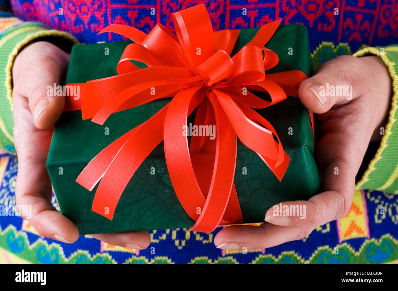Person holding a Christmas present Stock Photo - Alamy