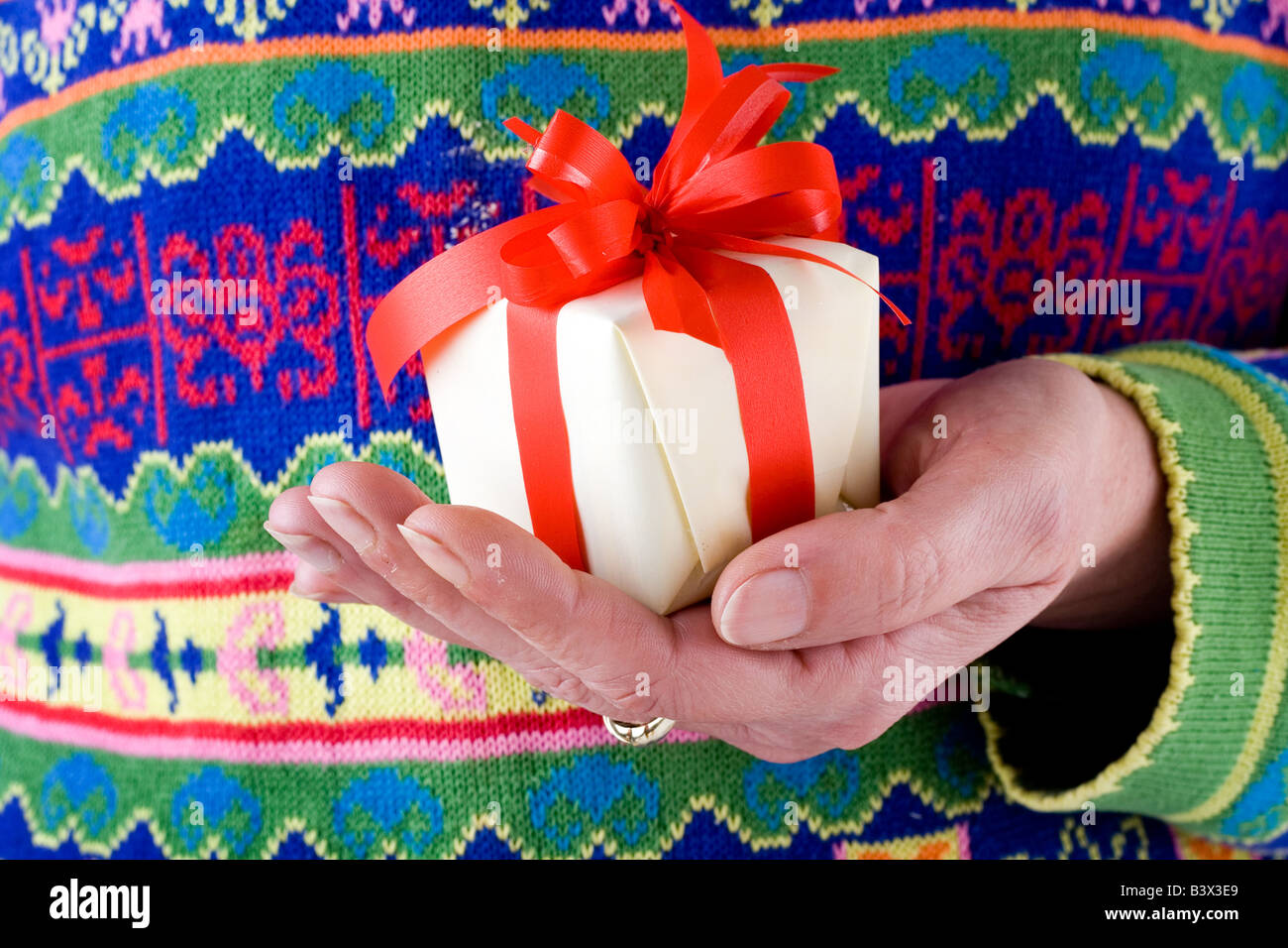 Person holding a Christmas present Stock Photo - Alamy