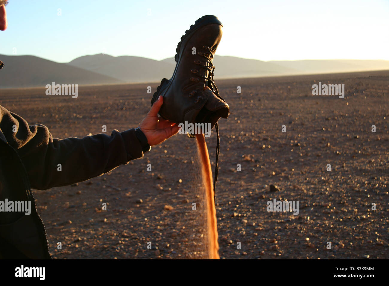 Sand running out of a boot in the Namibian Desert Stock Photo - Alamy