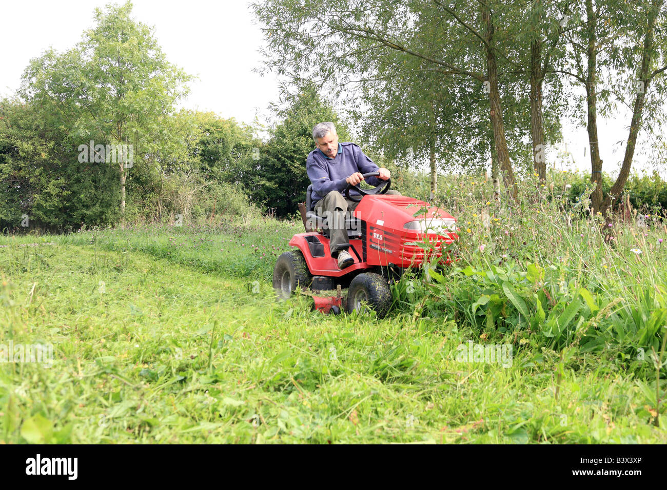 Ride on lawn mower mowing hi-res stock photography and images - Alamy