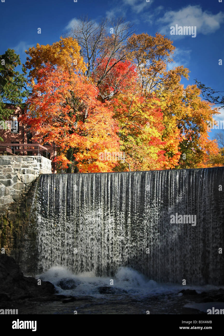 Bright waterfall with red and orange autumn trees Stock Photo - Alamy