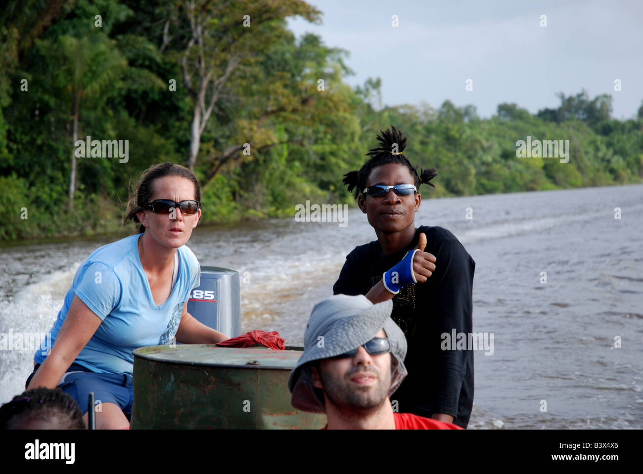 a french woman drives a pirogue down Maroni river in French Guyana ...