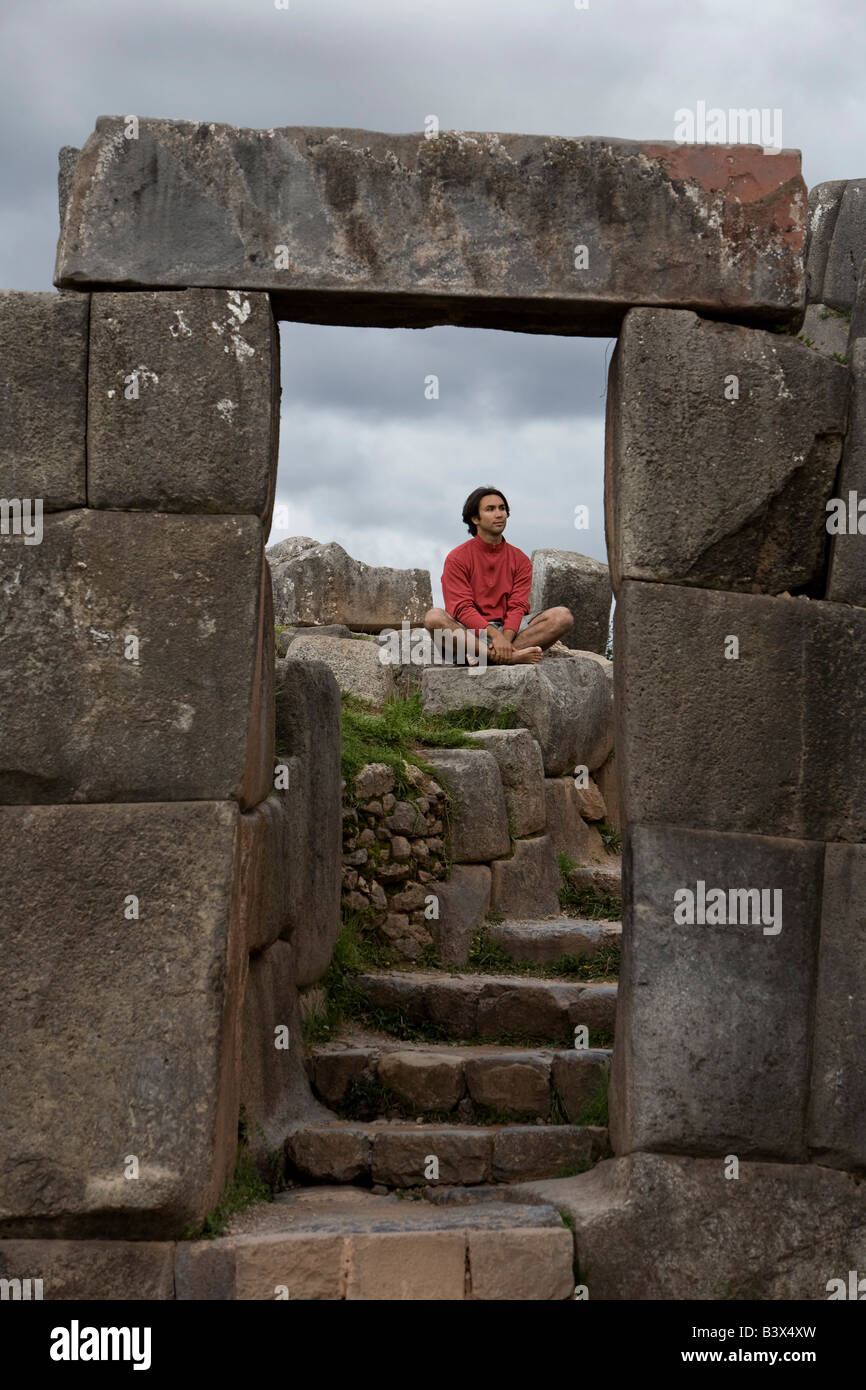 A young man meditates in ancient Incan ruins outside Cuzco, Peru Stock ...