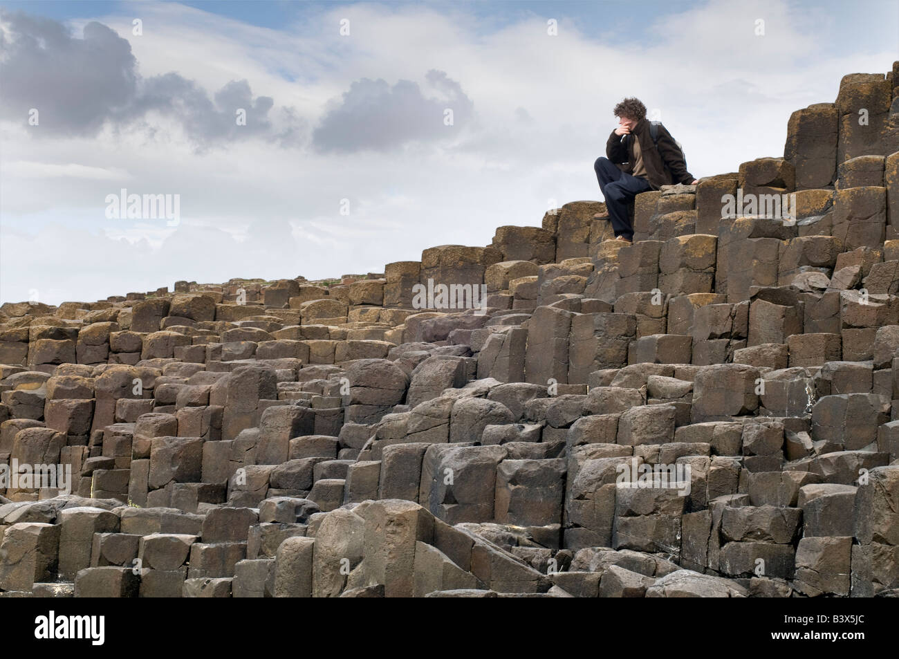 Man Sitting On The Basalt columns. Giants Causeway, Northern Ireland ...
