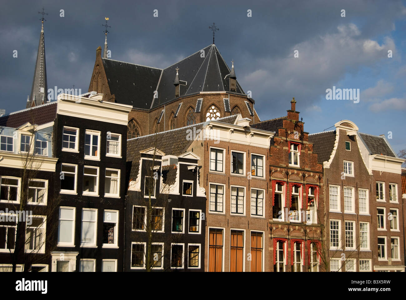 Amsterdam row houses and church Stock Photo - Alamy